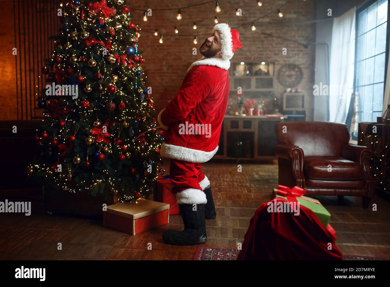 Bad drunk Santa claus urinating on christmas tree Stock Photo - Alamy