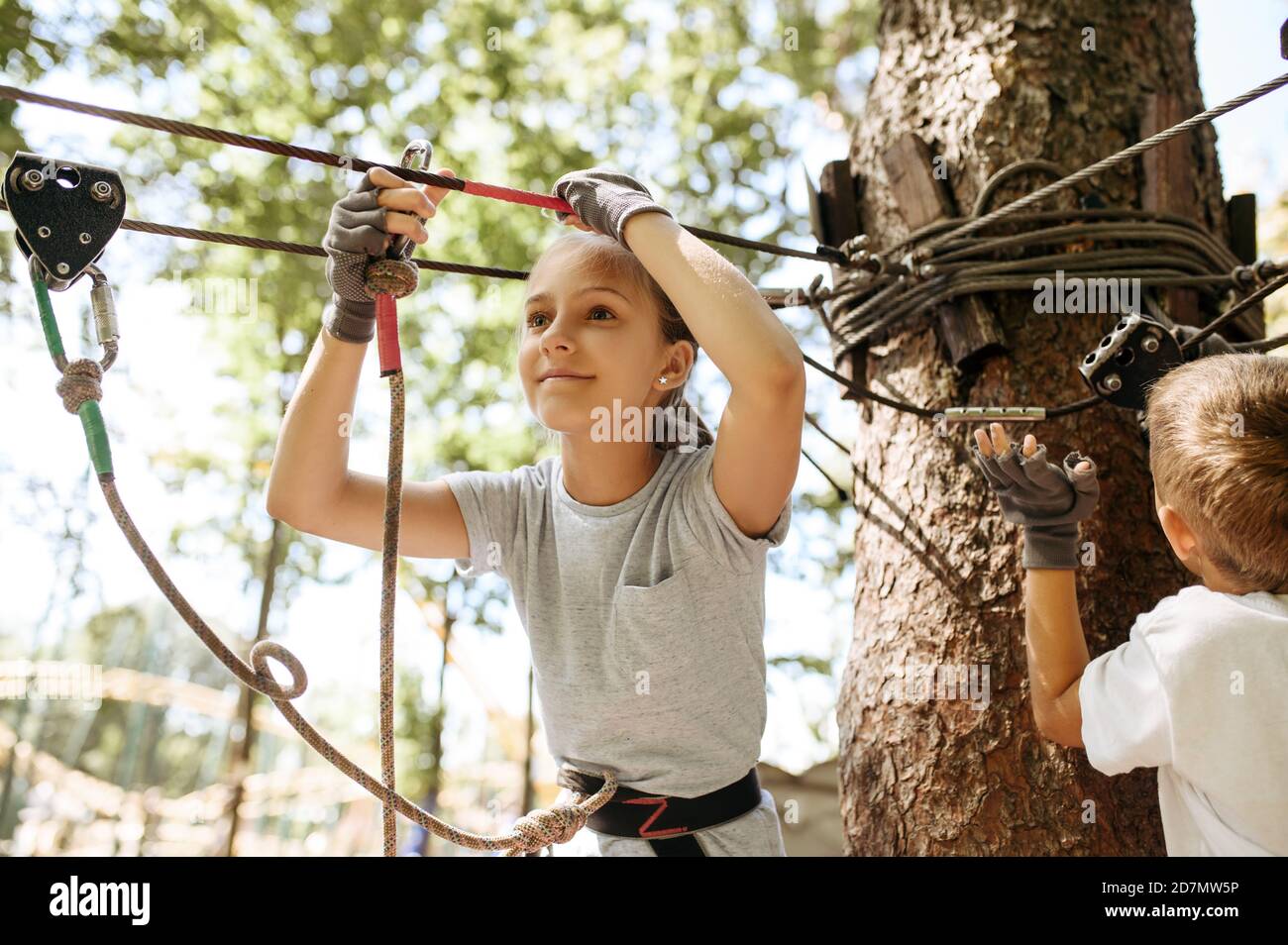 Little kids climbs in rope park, playground Stock Photo - Alamy