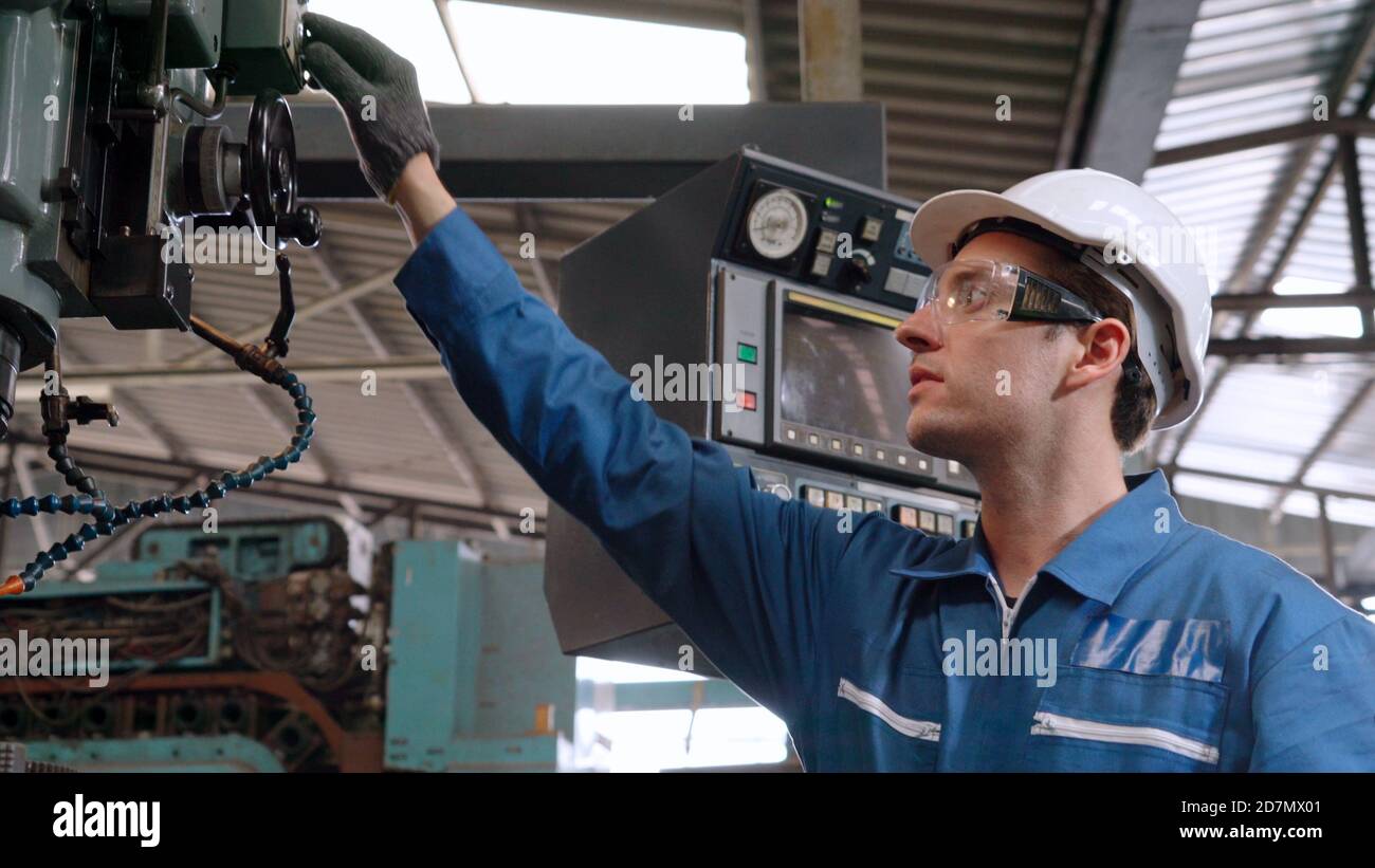 Smart factory worker using machine in factory workshop . Industry and ...