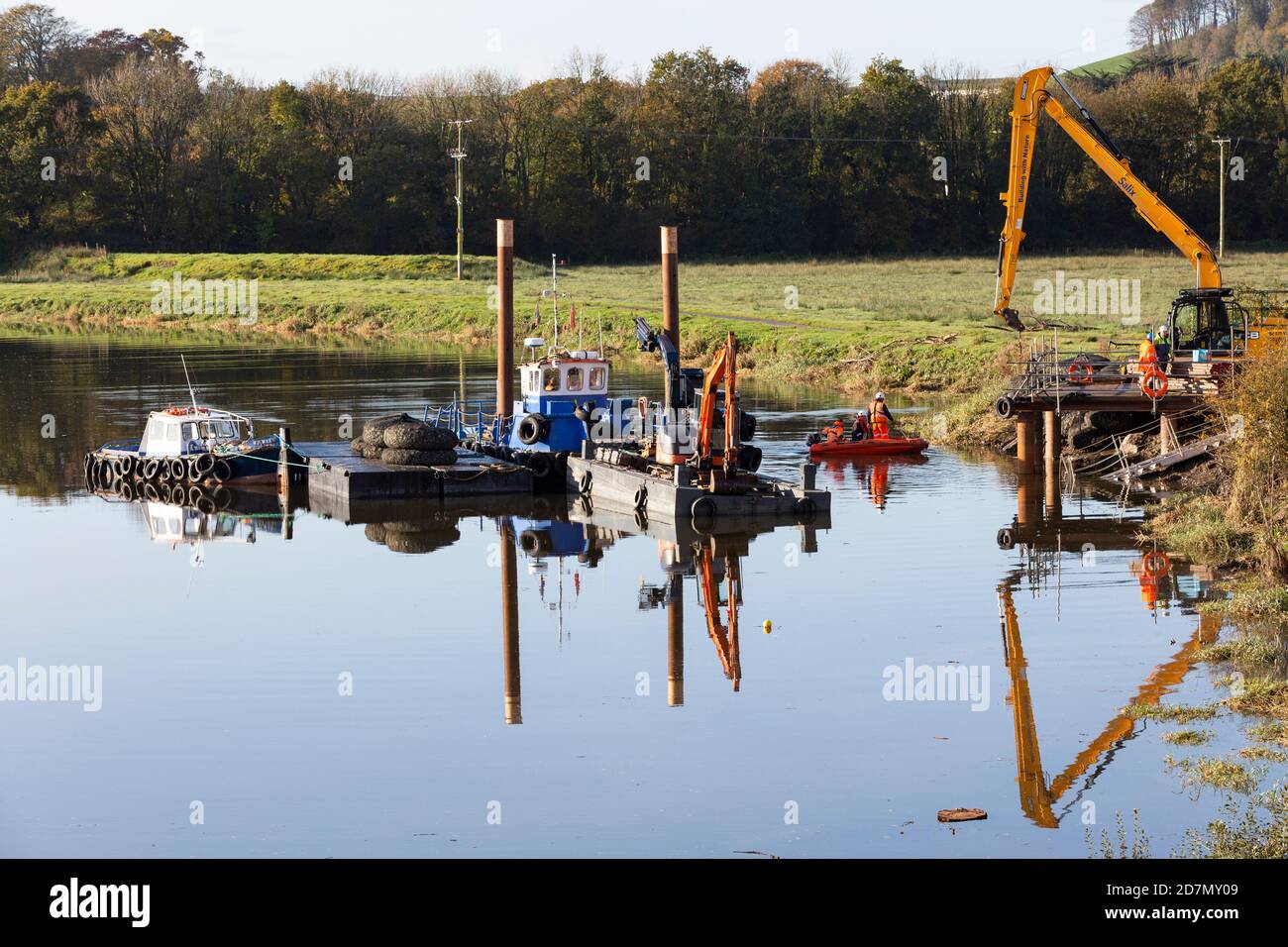 Plant, machinery, boats, barges and workmen on the Towy River in ...