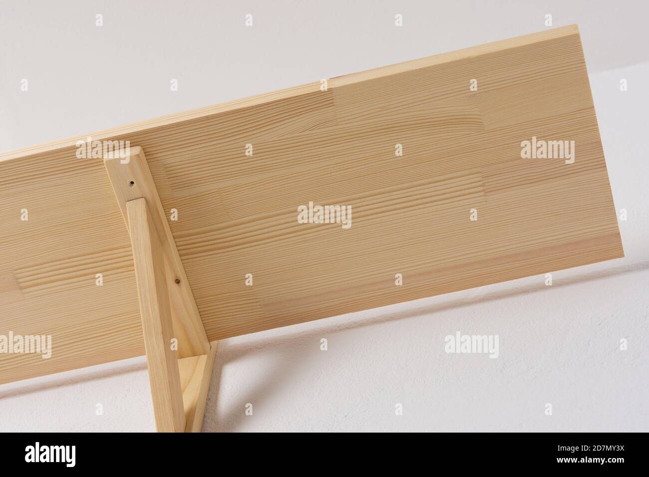 The process of attaching a wooden shelf to the wall, shelf corners ...