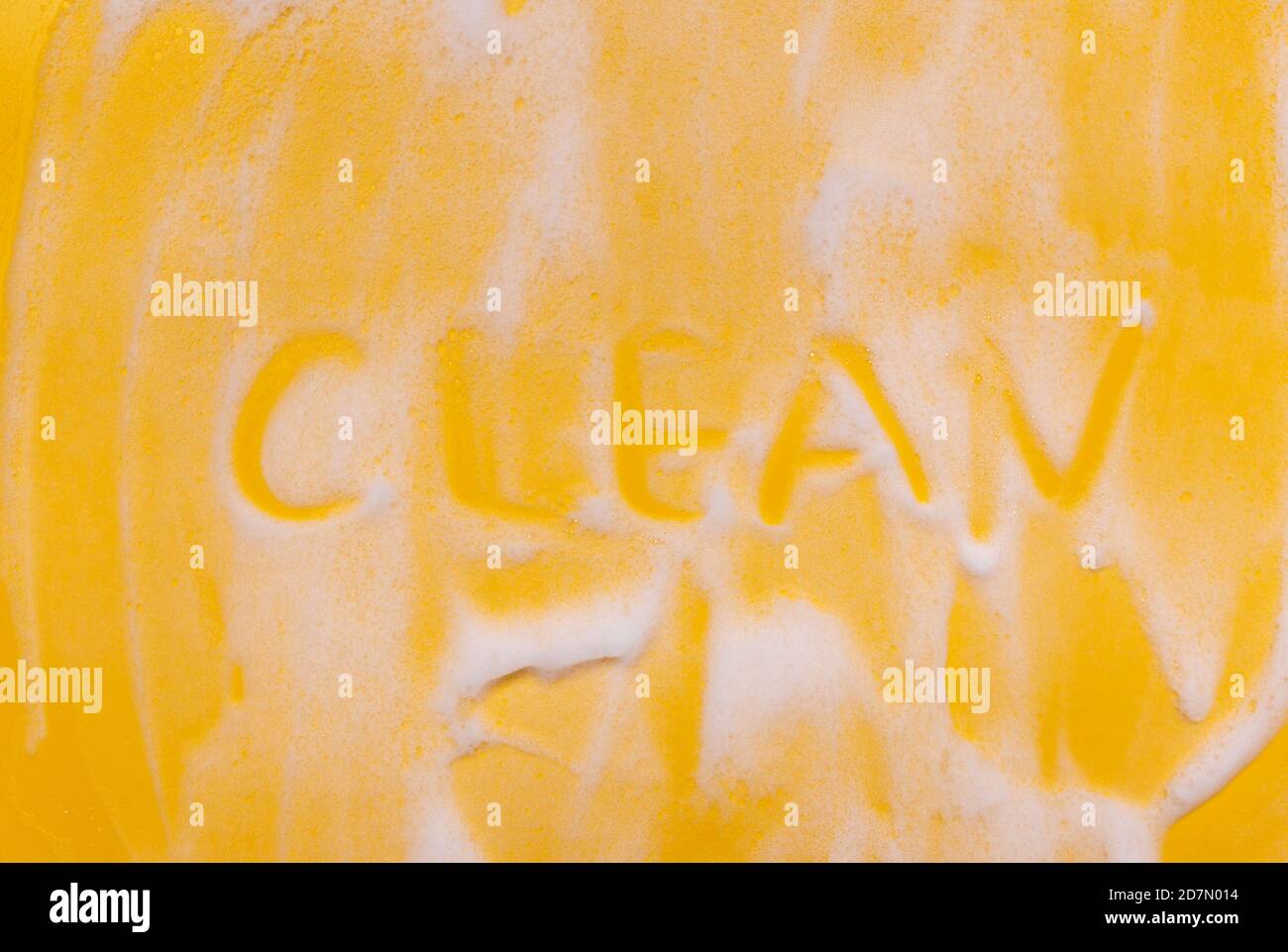 the word clean written in foam on a yellow background Stock Photo - Alamy