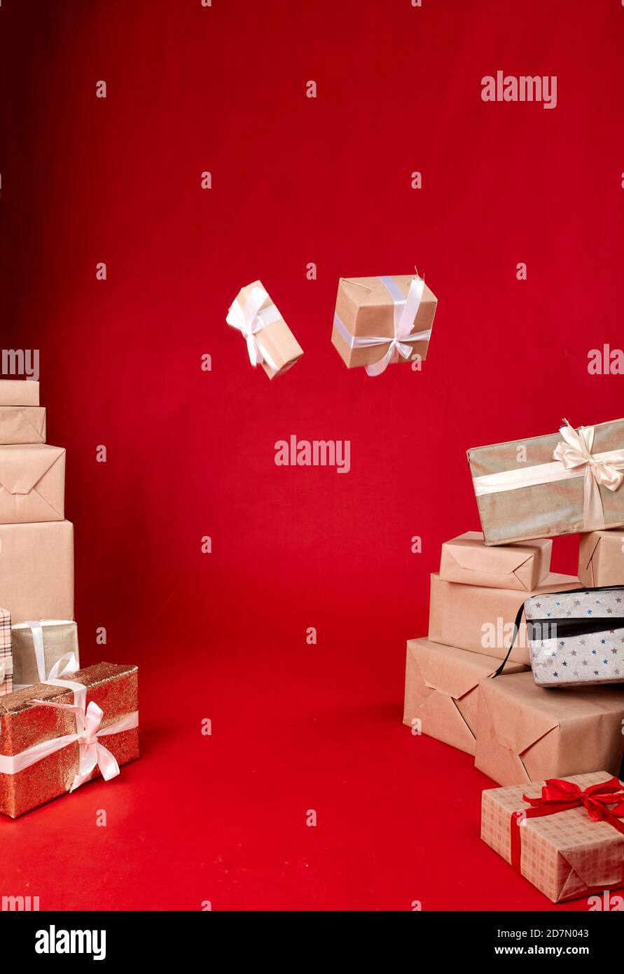 gifts in the air on a red background Stock Photo - Alamy