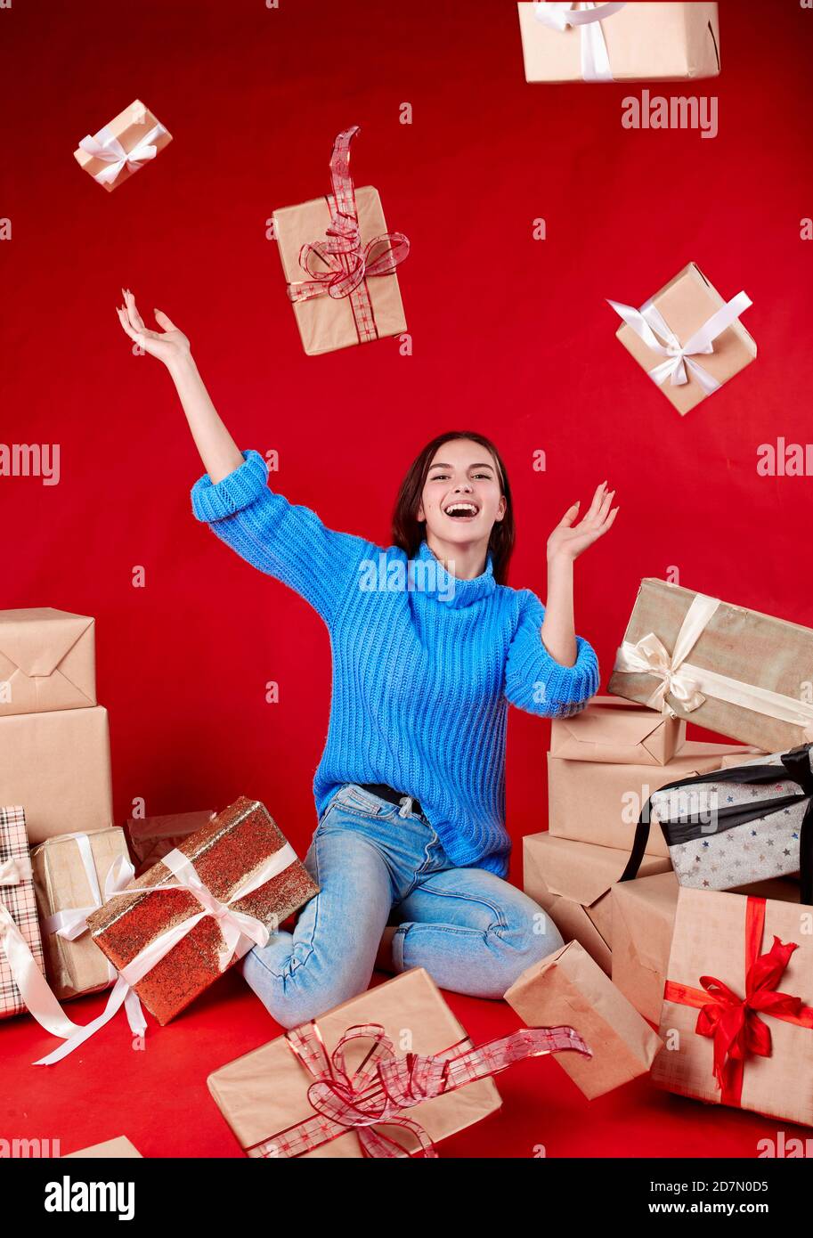 gifts fly to the girl from all sides on a red background Stock Photo ...