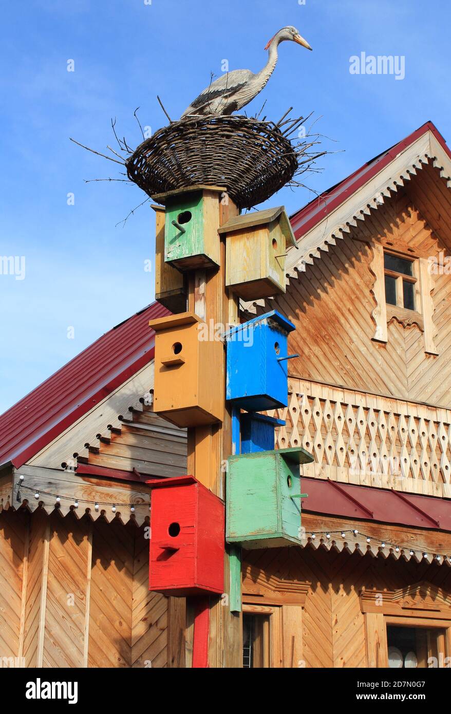 Colorful birdhouses and a decorative nest with a stork. Landscape ...