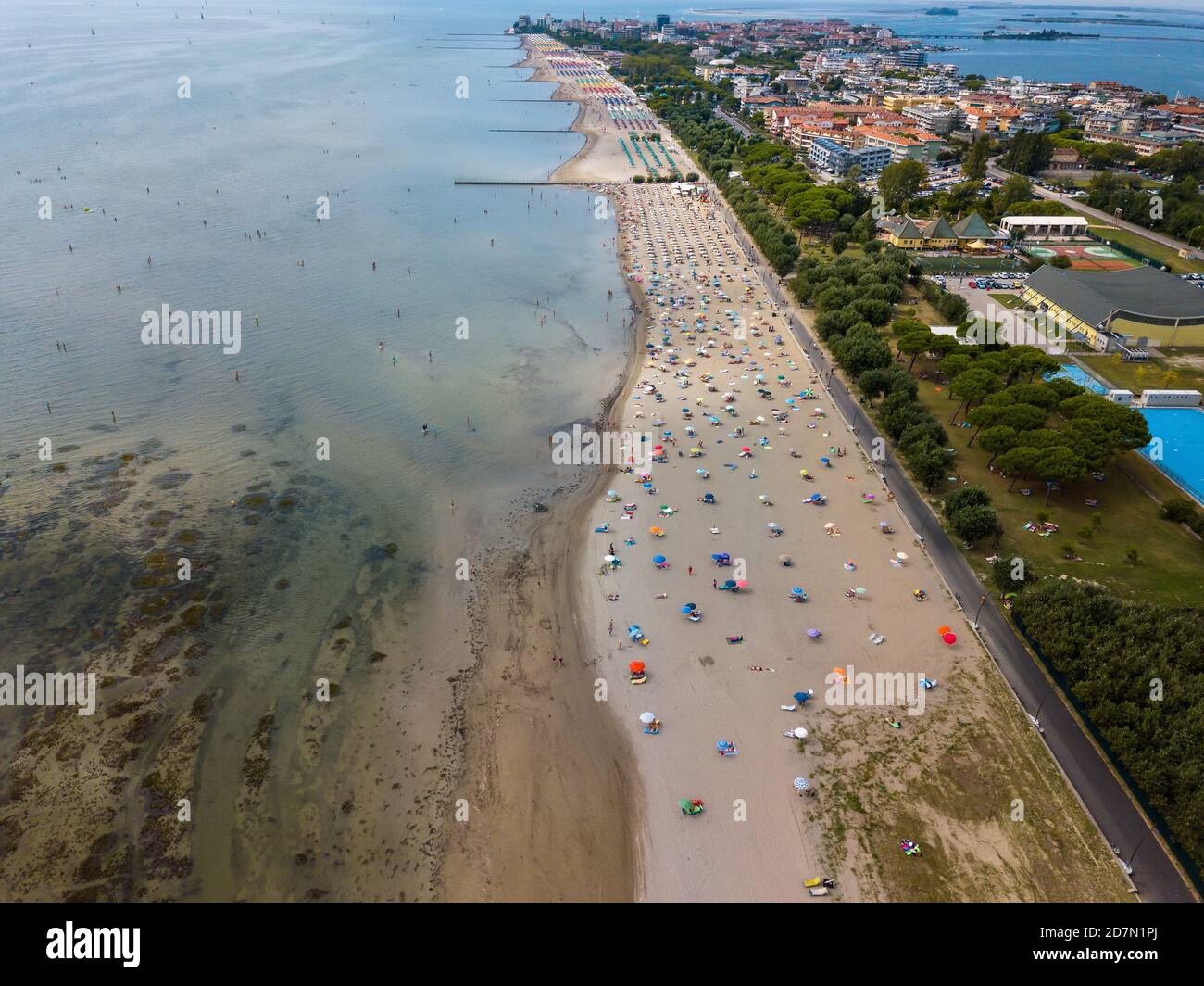 Aerial view of unidentifiable people enjoying summer at the beach of ...