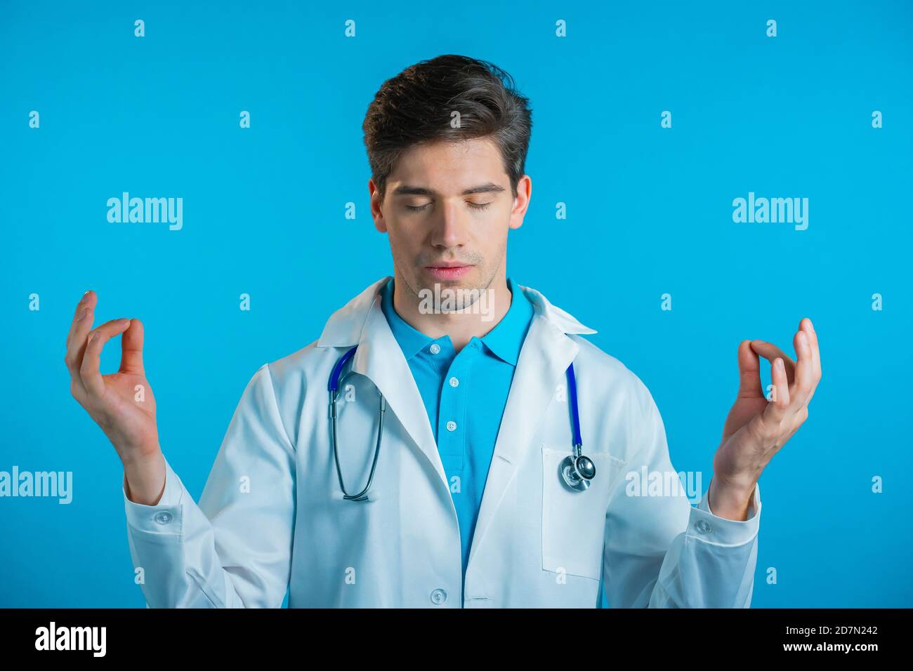 Calm doctor relaxing, meditating. Man calms down, breathes deeply with ...