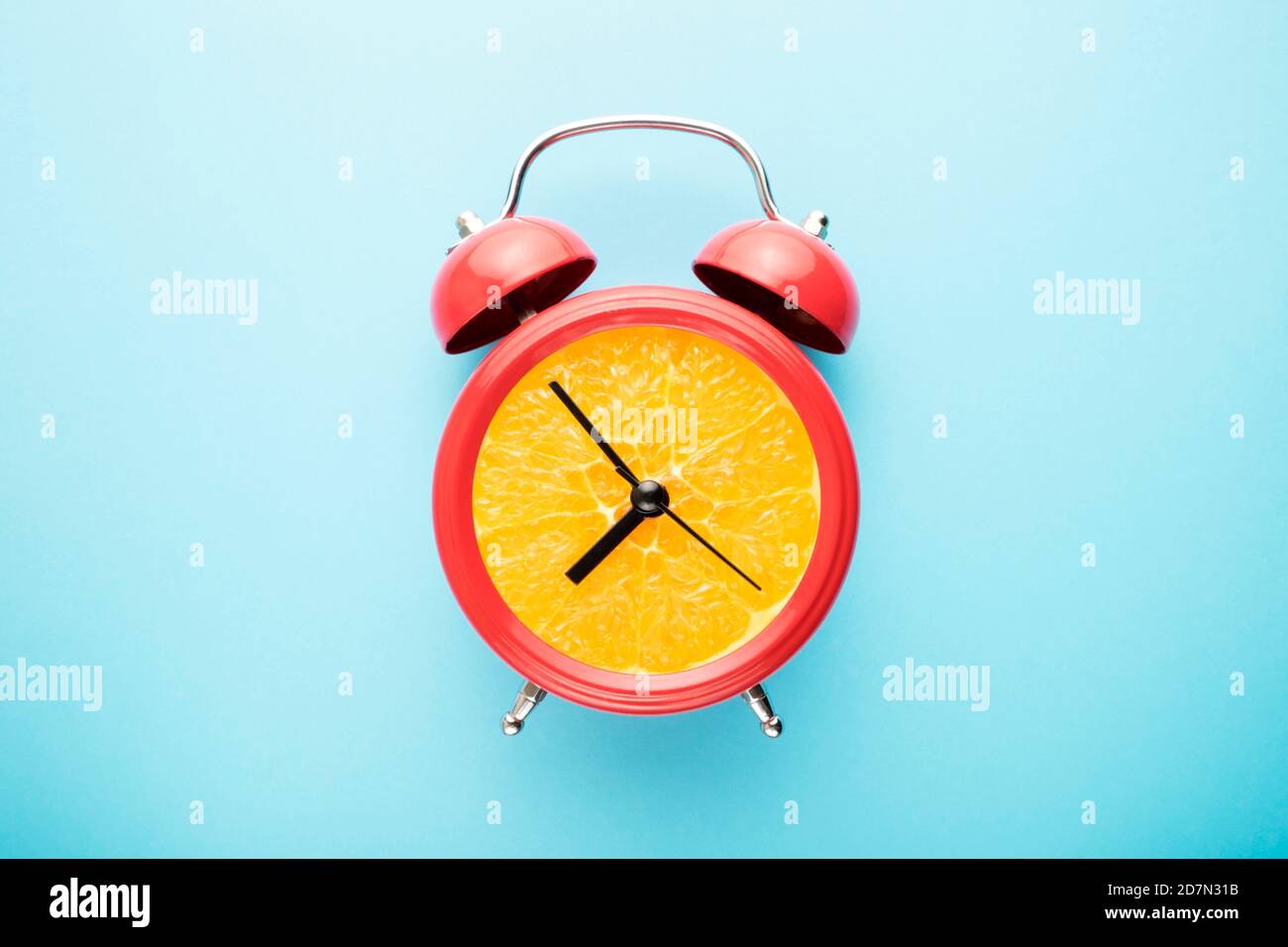 Red alarm clock with a fresh orange dial Stock Photo - Alamy
