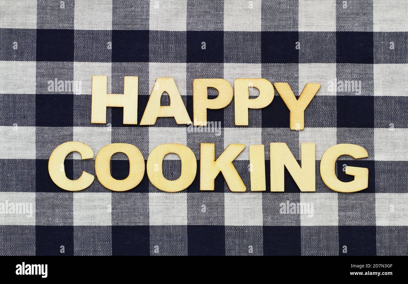 Happy cooking written with wooden letters on navy blue and white ...