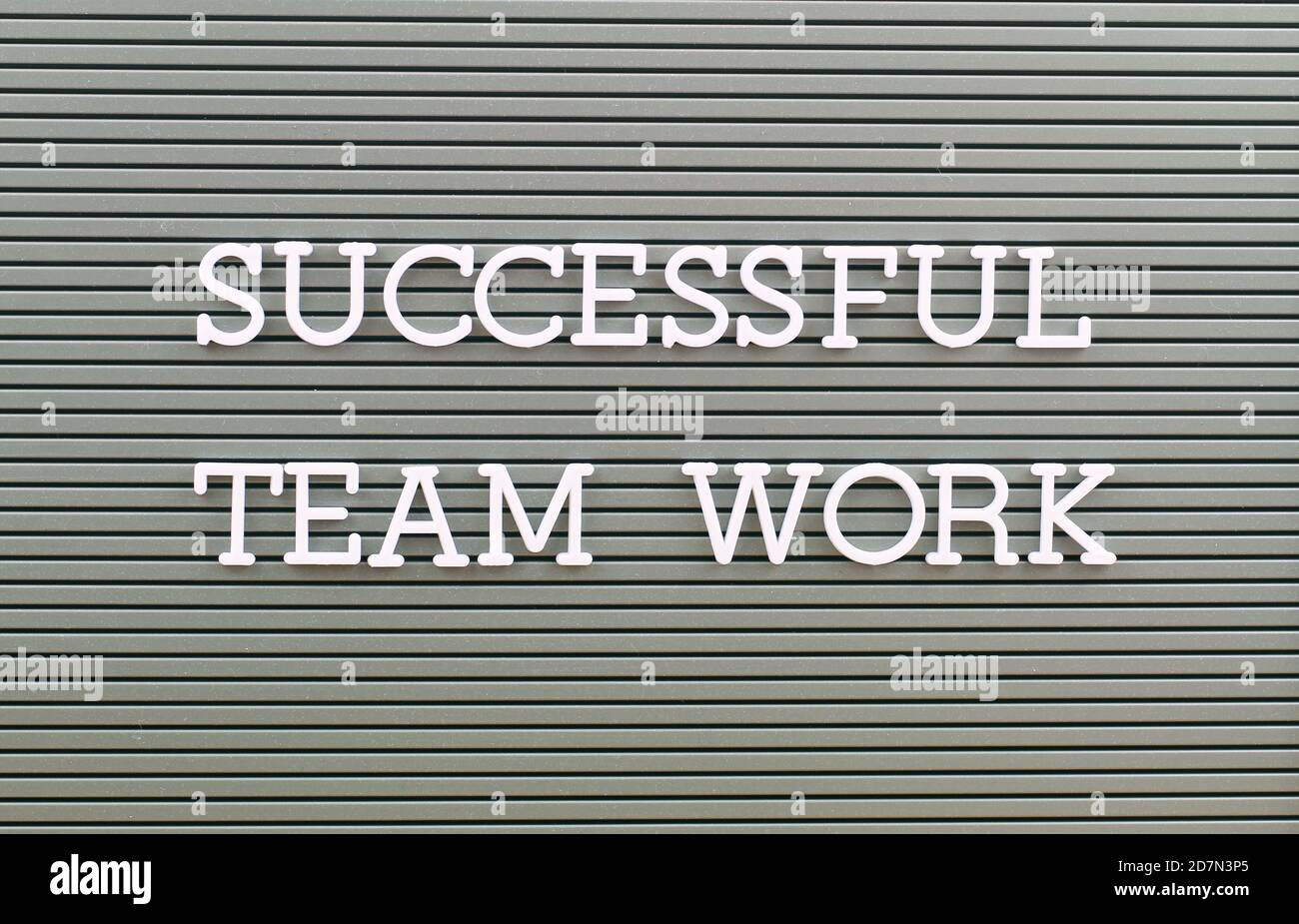 Successful team work written with white plastic letters on grey board ...
