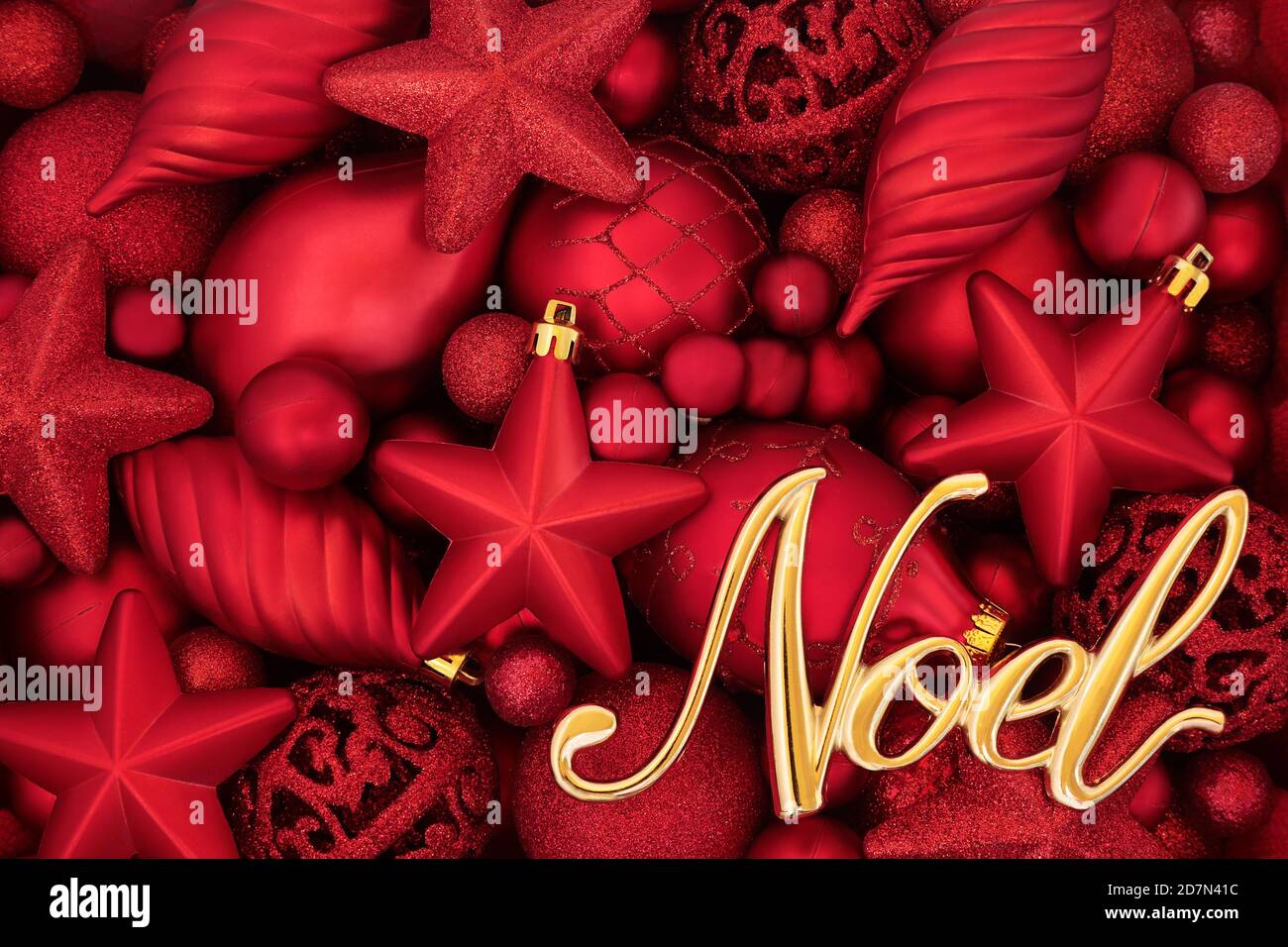 Gold Noel sign with red bauble decorations forming an abstract ...