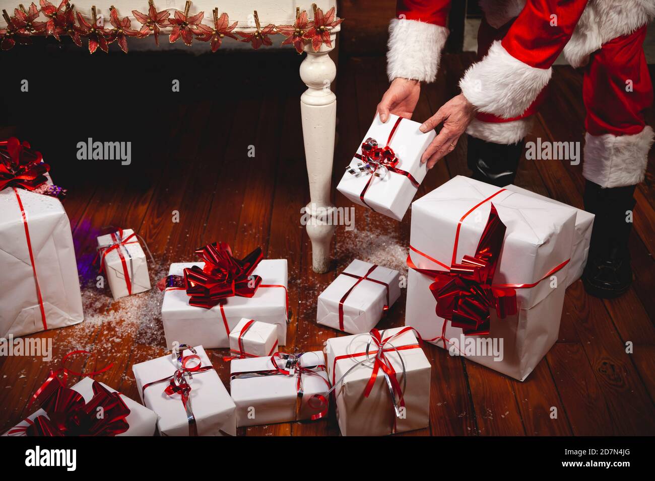 santa claus is delivering gift packages to a house on christmas night ...