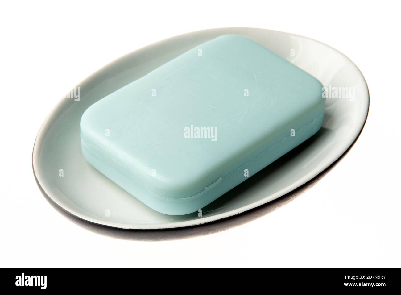 A bar of natural blue soap in a soap plate isolated on white background ...