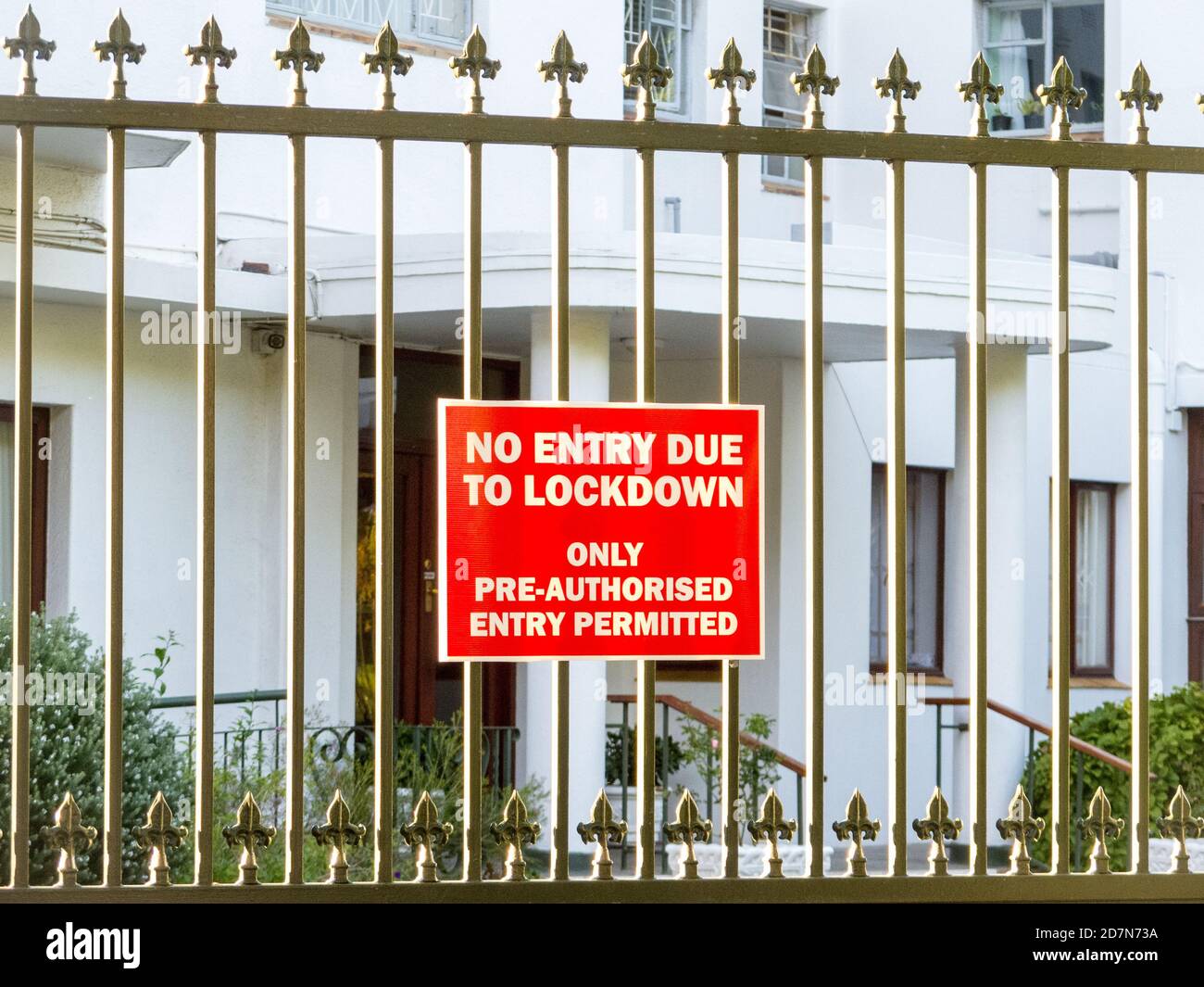 warning sign on metal gate with text, words no entry due to lockdown ...