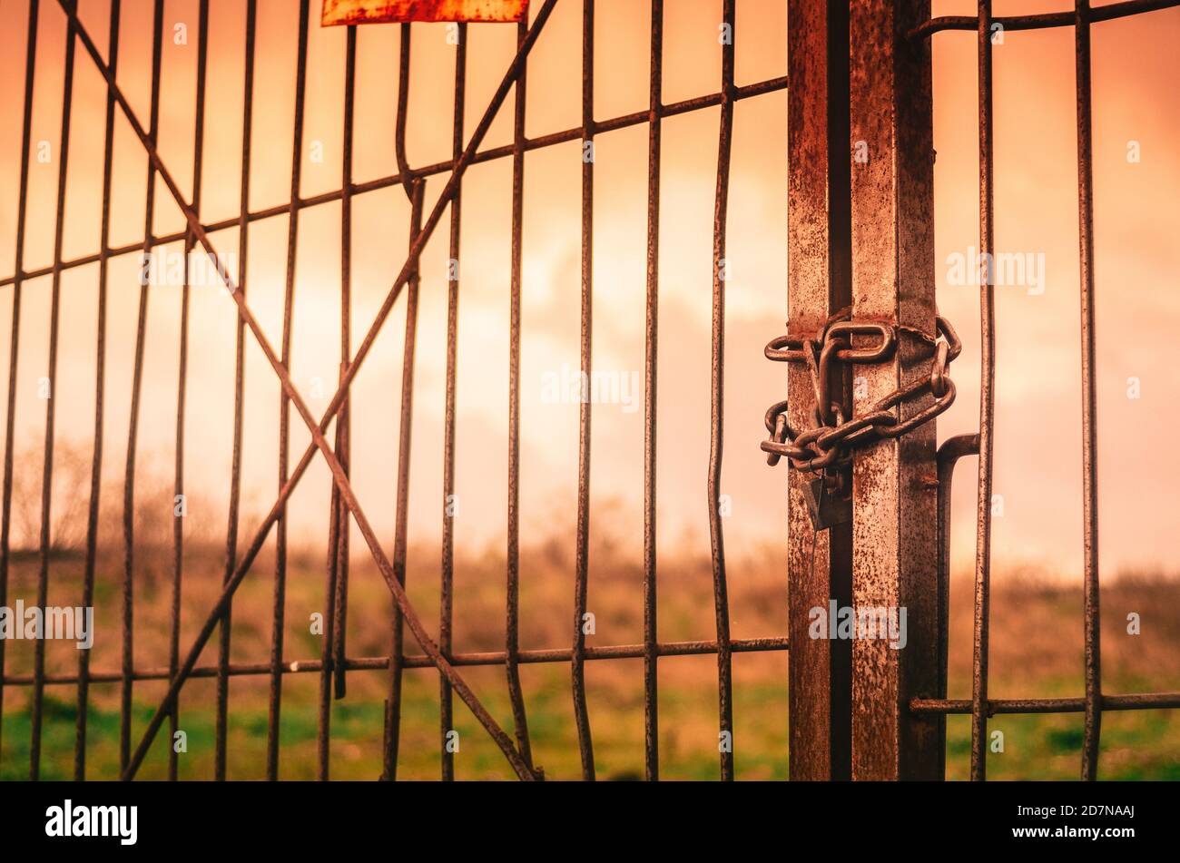 Old metal gate closed with a rusty chain Stock Photo - Alamy