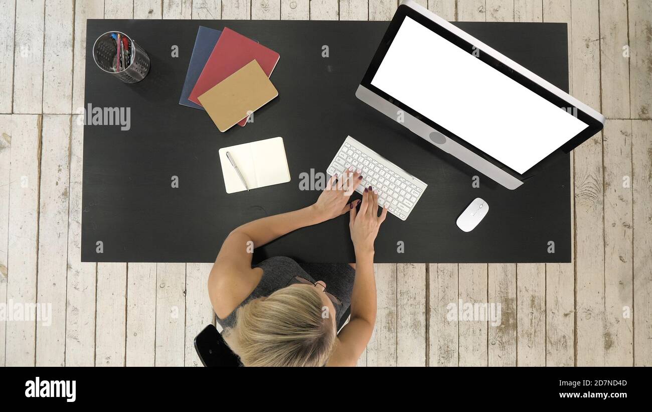 Young woman working at her office desk with computer. White Disp Stock ...