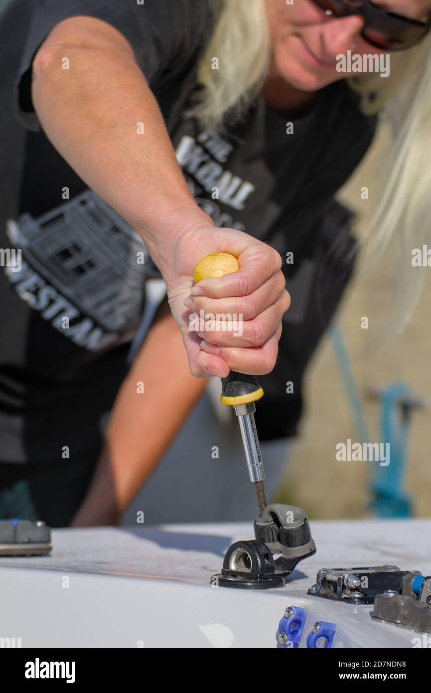 Lady, Female With Blonde Hair Using A Screwdriver To Tighten A Screw On ...
