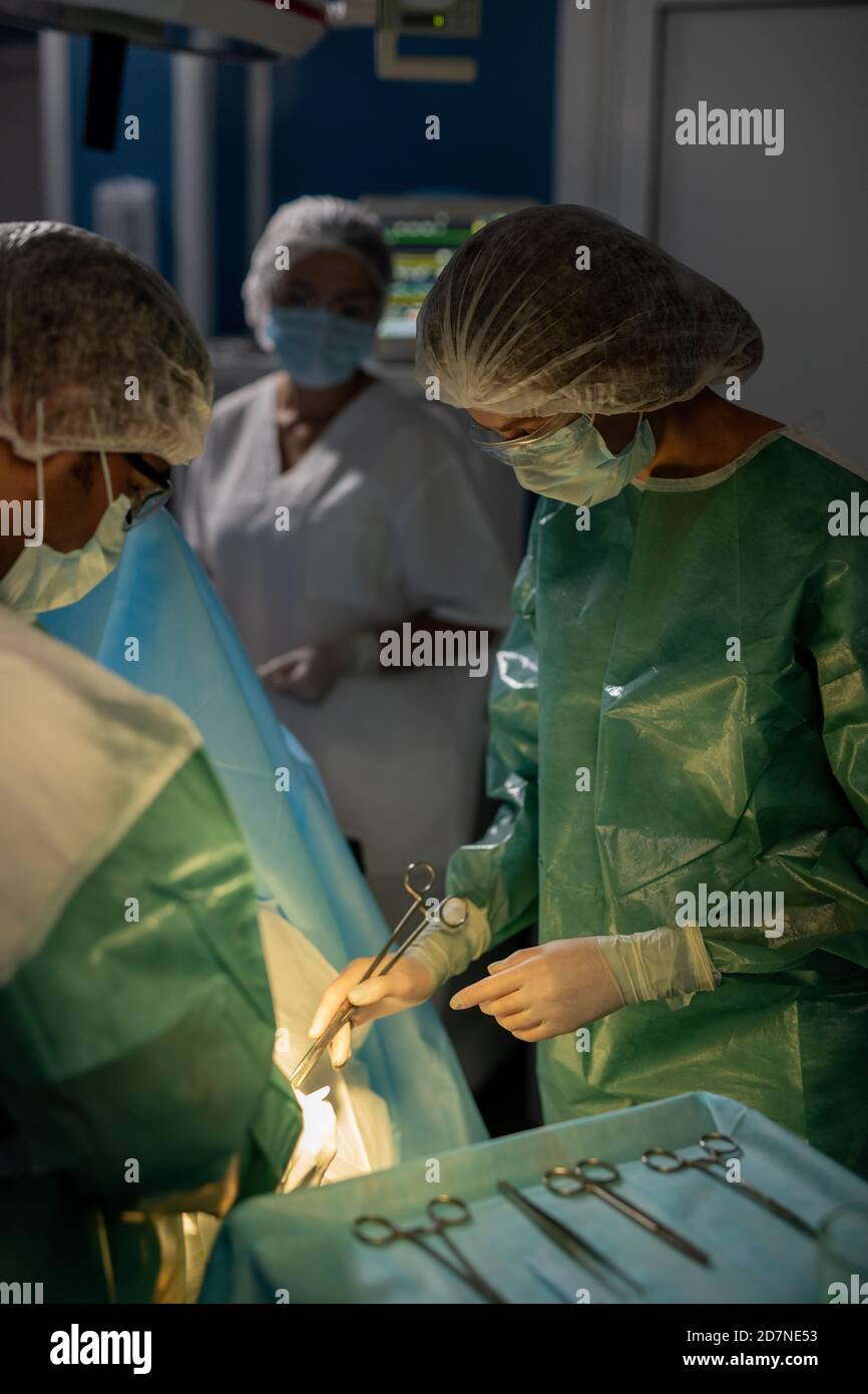 Contemporary surgeons doing operation against their assistant in ...