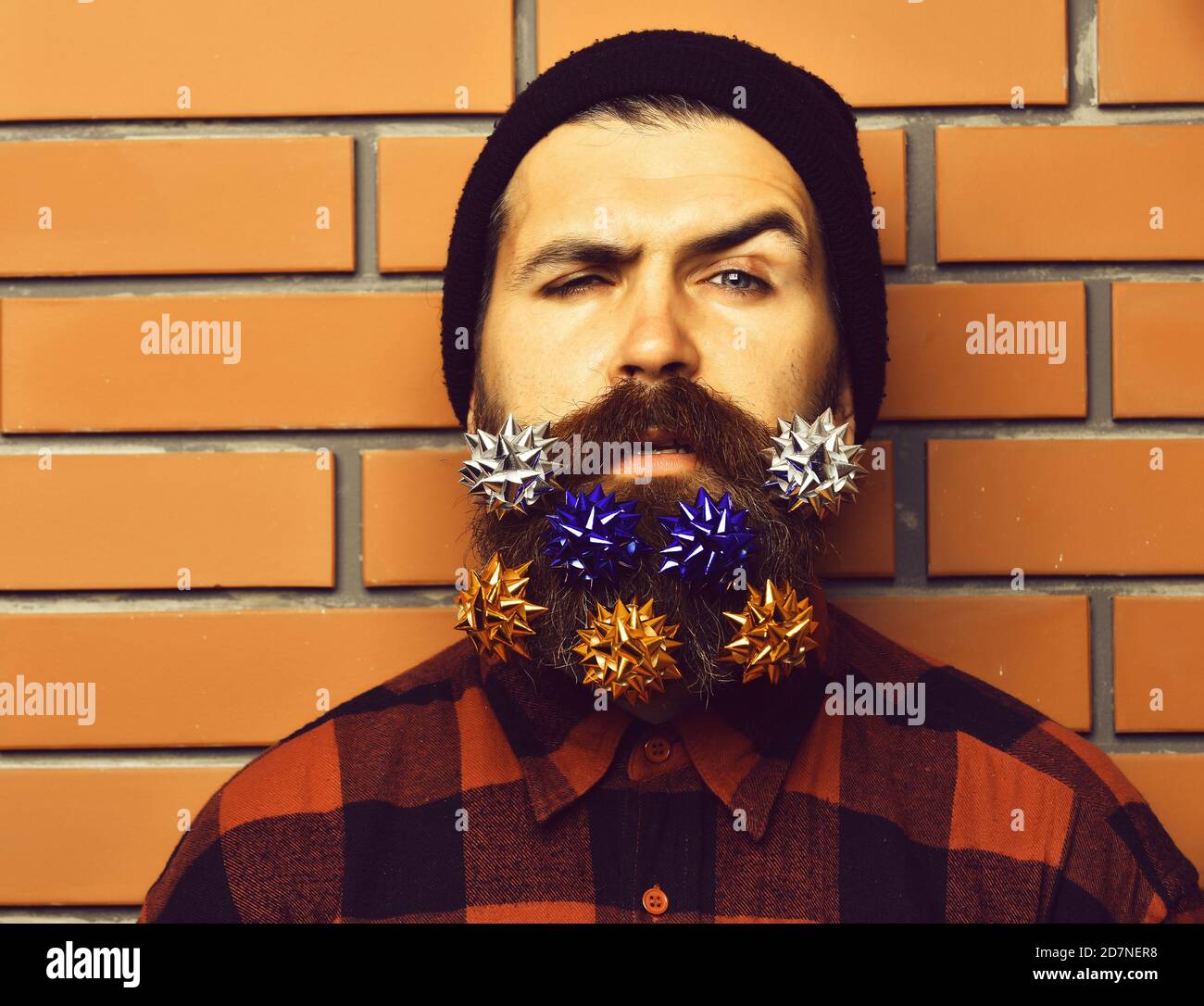 Bearded man with flowers or bows in long beard. Brutal caucasian ...