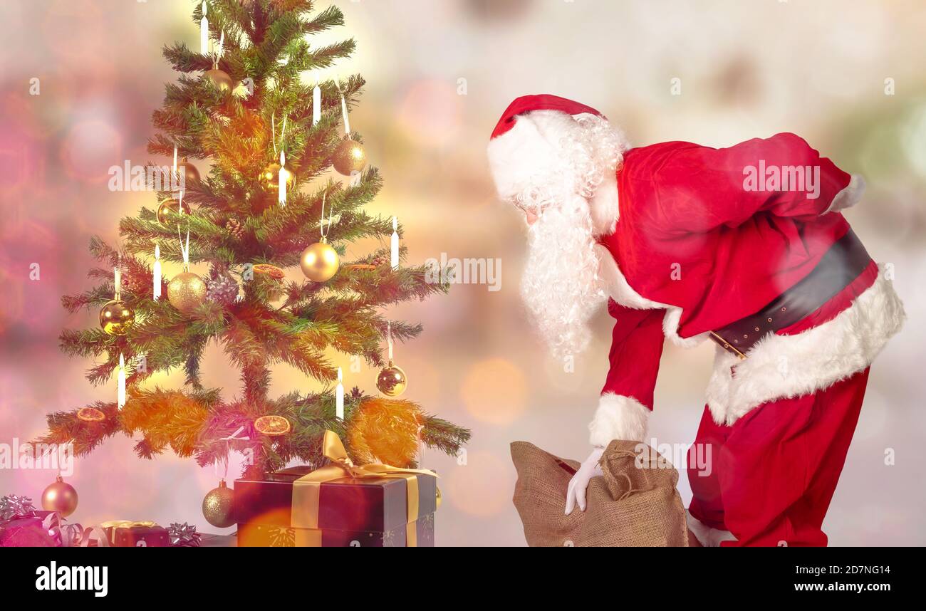 santa claus has back pain from handing out gifts Stock Photo - Alamy