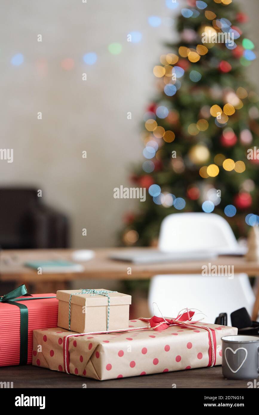 Stack of packed Christmas gifts wrapped into paper and bound with ...