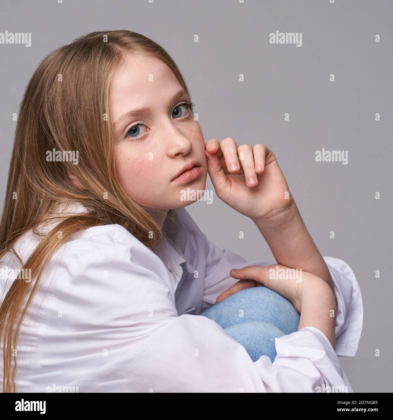 Young beautiful girl. Serious model with hand near face Stock Photo - Alamy