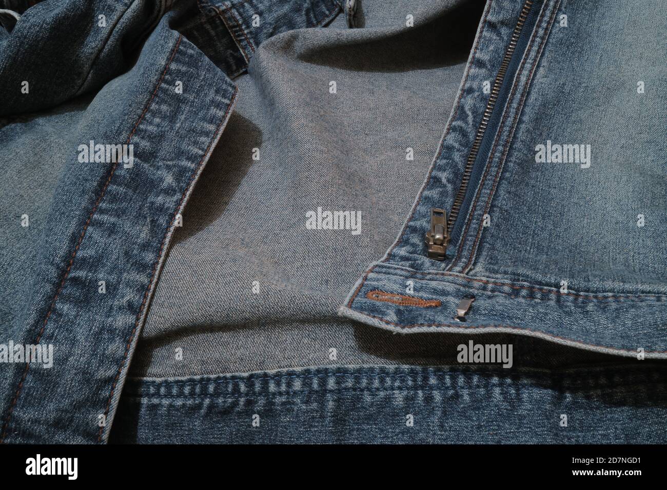 Textured background of blue denim jeans with seam and thread stitch ...