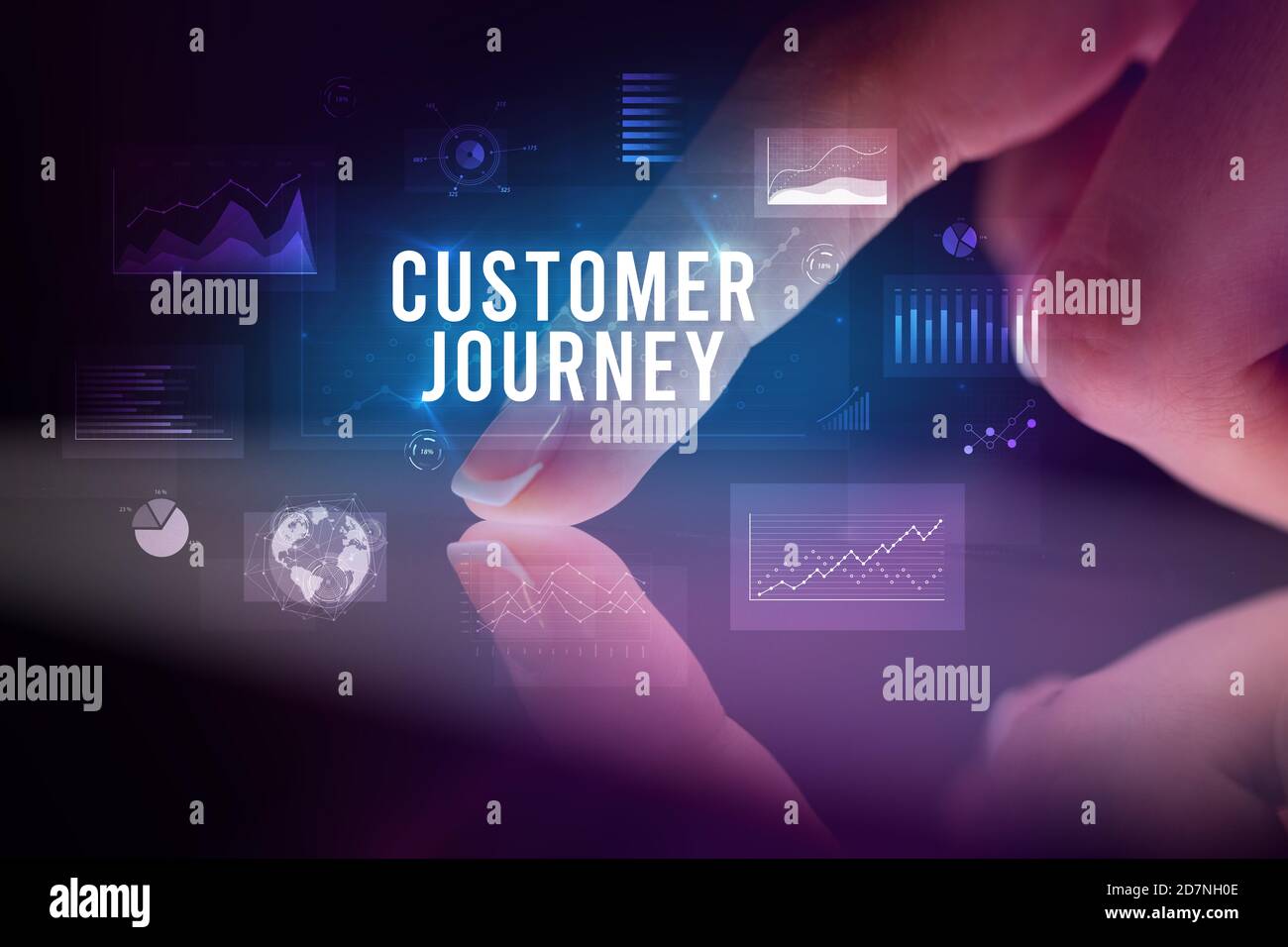 Finger touching tablet with charts and CUSTOMER JOURNEY inscription ...