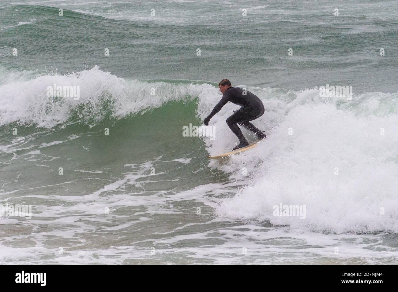 Surfer surfing at Boscombe, Bournemouth in October, UK Stock Photo - Alamy