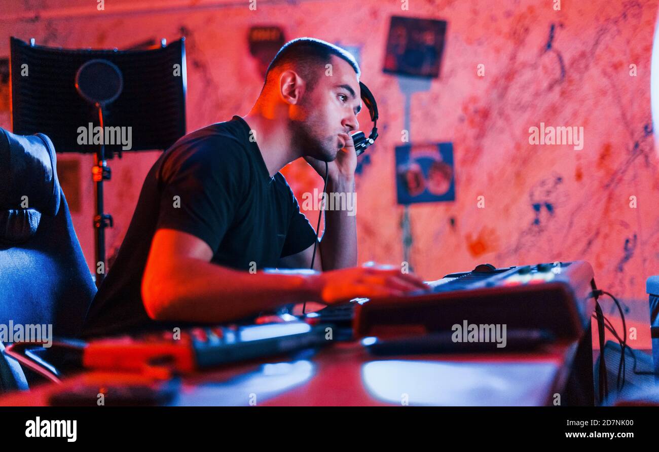 Sound engineer working and mixing music indoors in the studio Stock ...