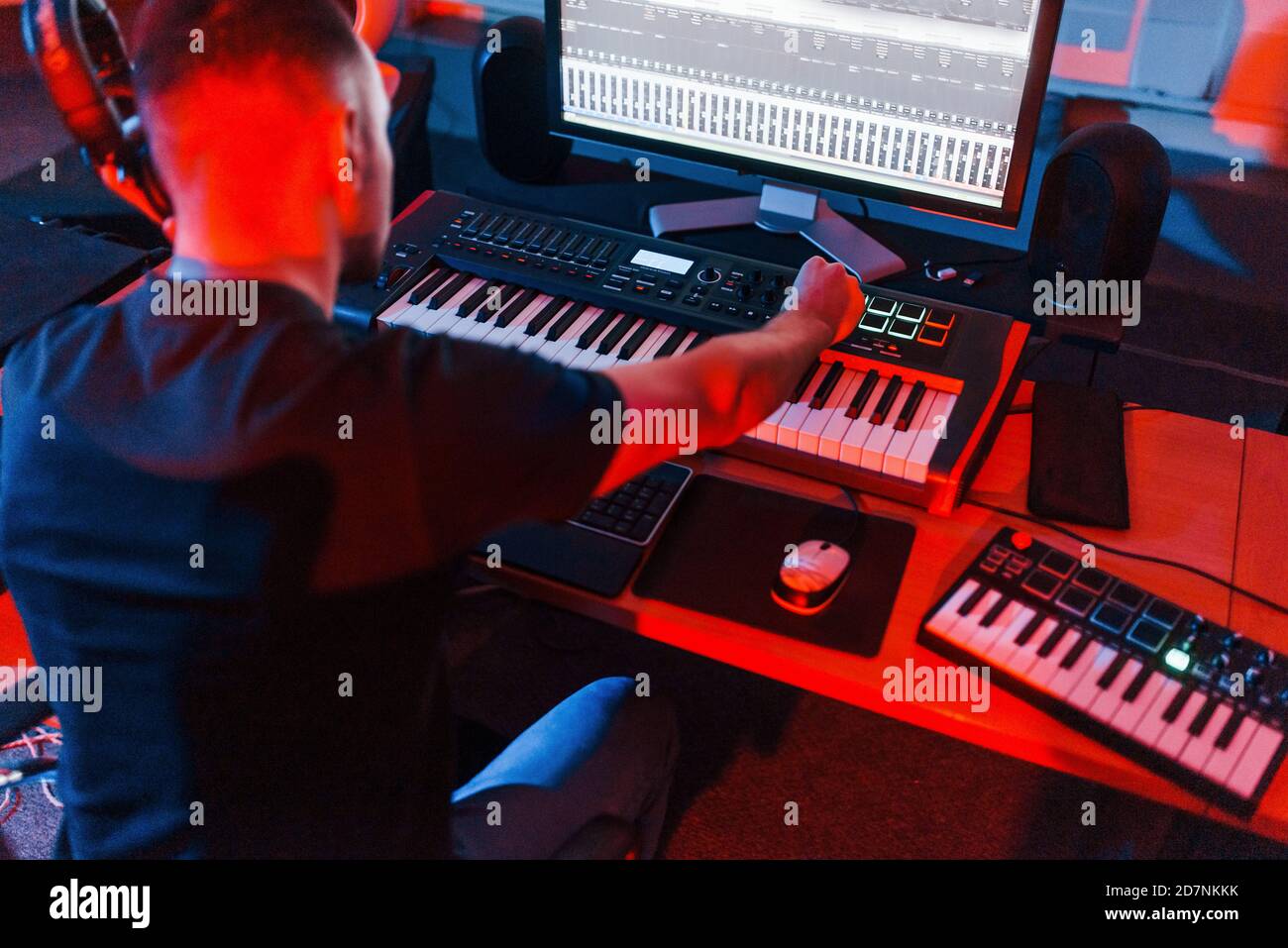 Professional sound engineer working and mixing music indoors in the ...