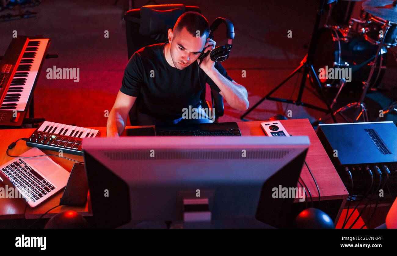 Professional sound engineer working and mixing music indoors in the ...