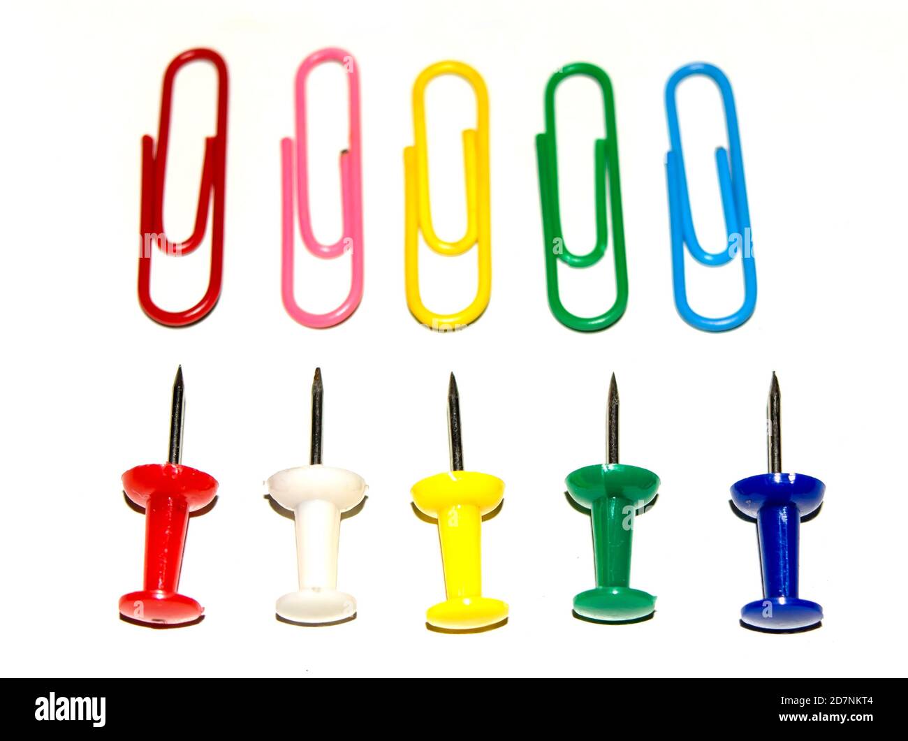Push pins and paper clips in different colors isolated on white ...