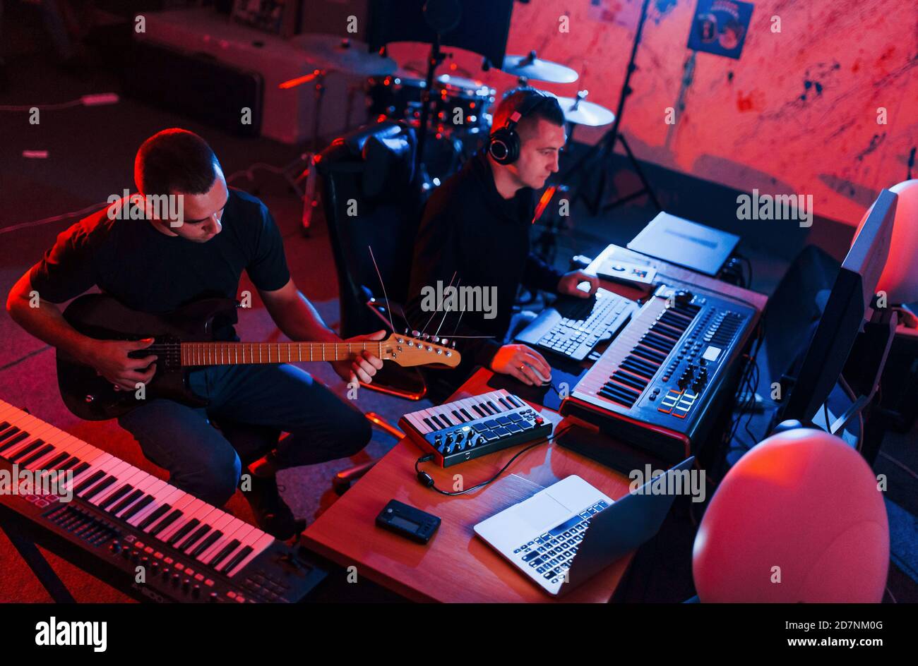 Sound engineer have recording session with guitarist indoors in the ...