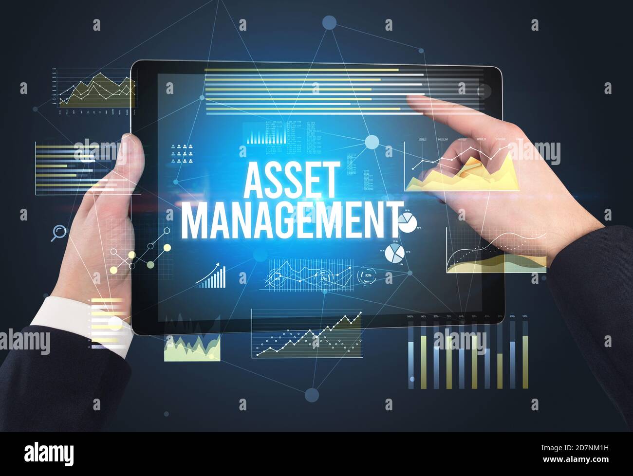 Close-up of hands holding tablet with ASSET MANAGEMENT inscription ...