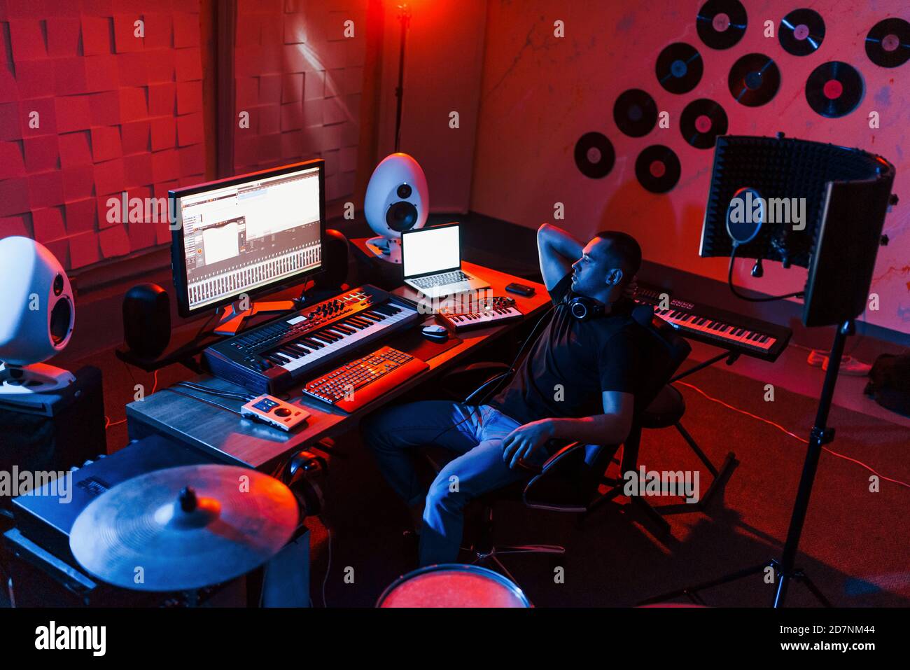 Sound engineer working and mixing music indoors in the studio near drum ...