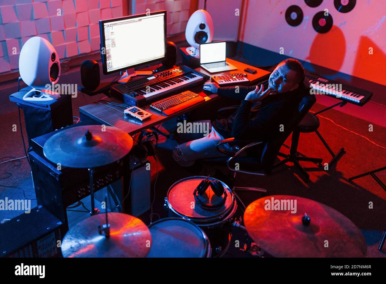 Sound engineer working and mixing music indoors in the studio near drum ...