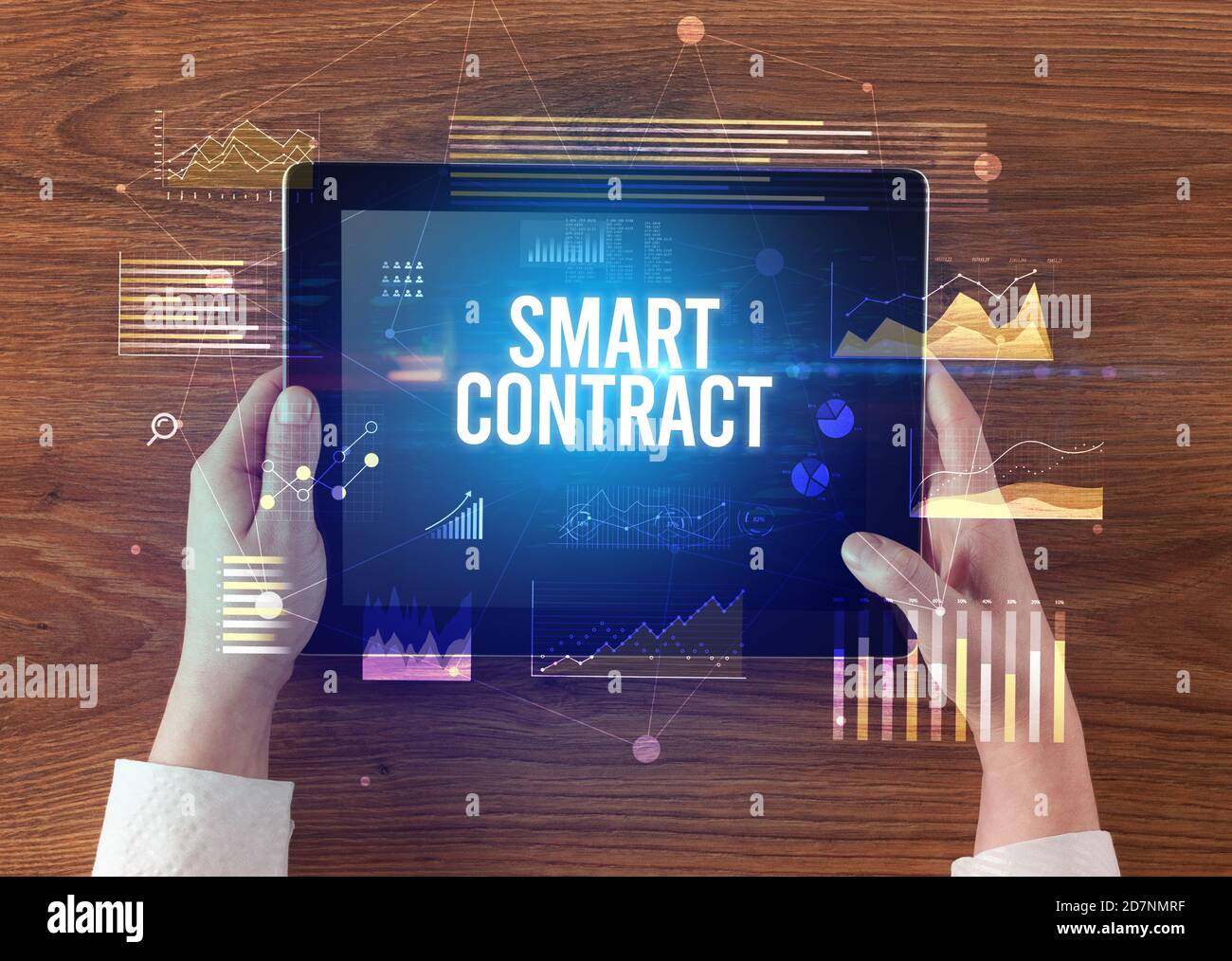 Close-up of hands holding tablet with SMART CONTRACT inscription ...