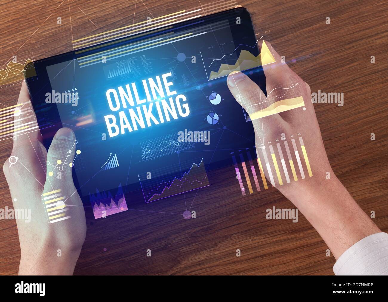 Close-up of hands holding tablet with ONLINE BANKING inscription ...