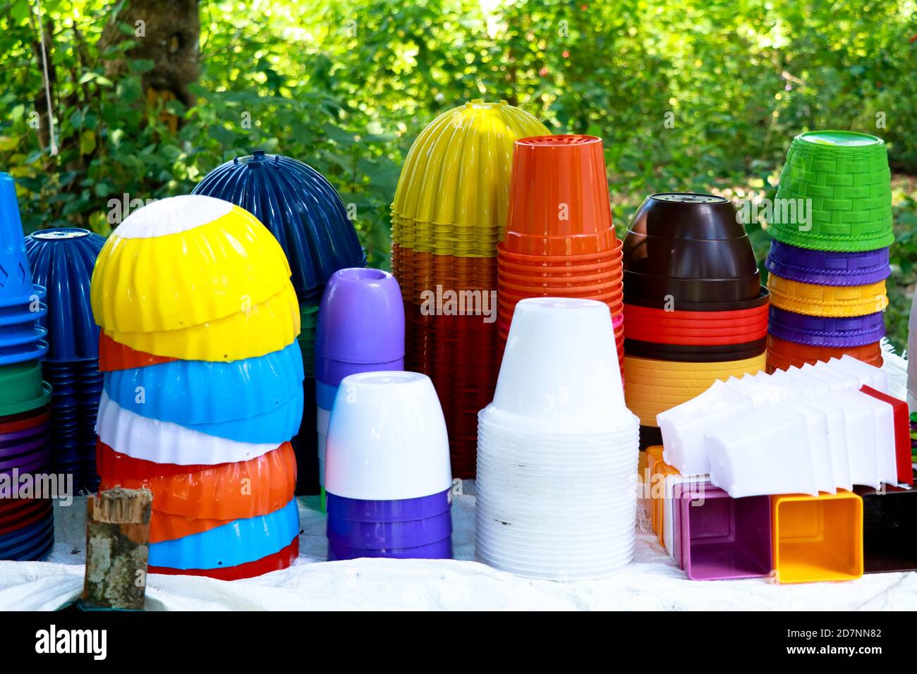 Plastic flower vases in different colors for sale on the roadside ...
