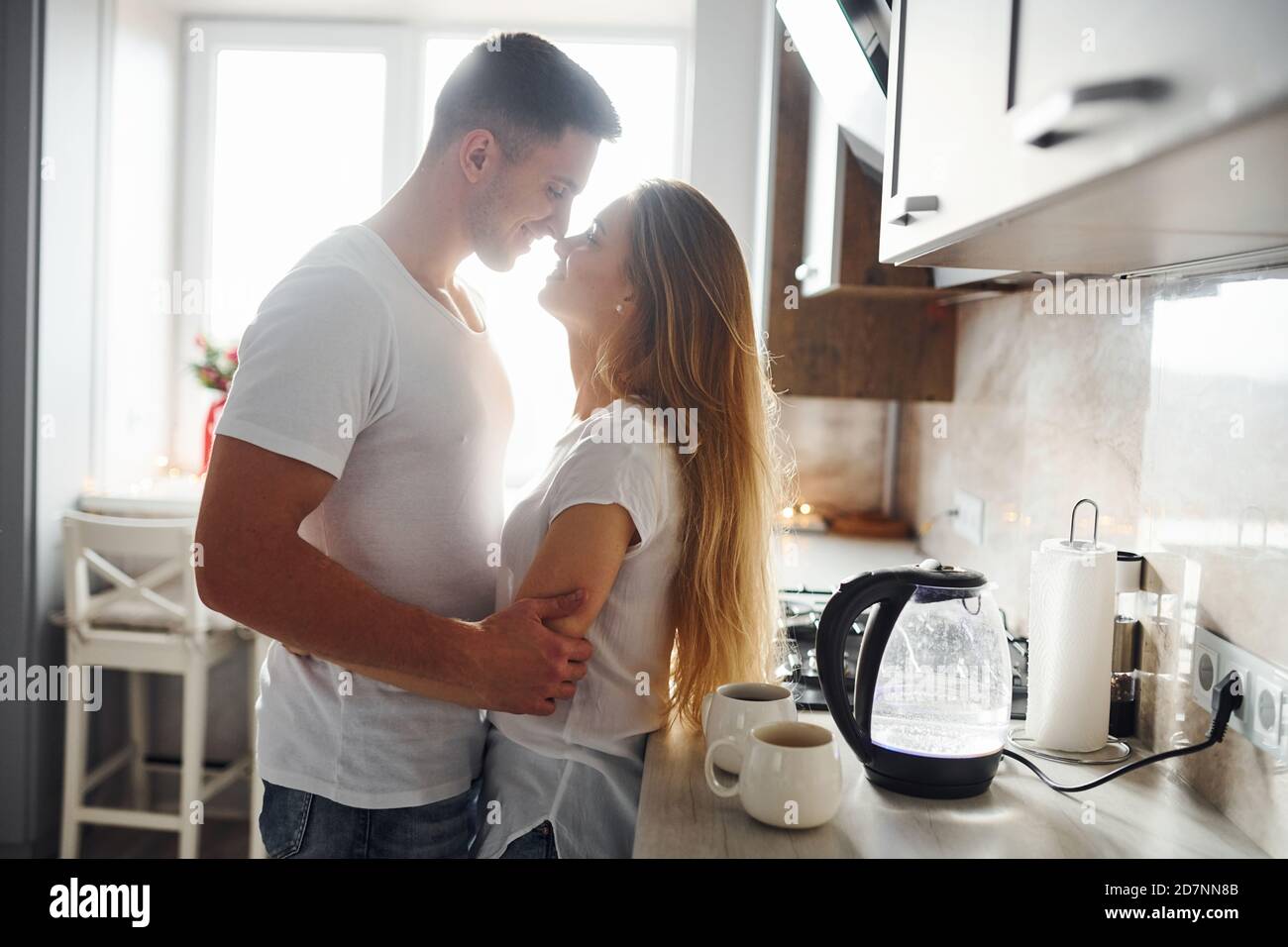 Young couple at morning together standing on the modern kitchen Stock Photo - Alamy