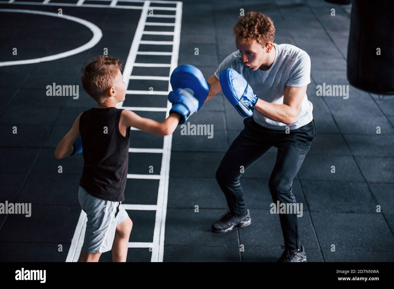 Young trainer teaches kid boxing sport in the gym Stock Photo - Alamy