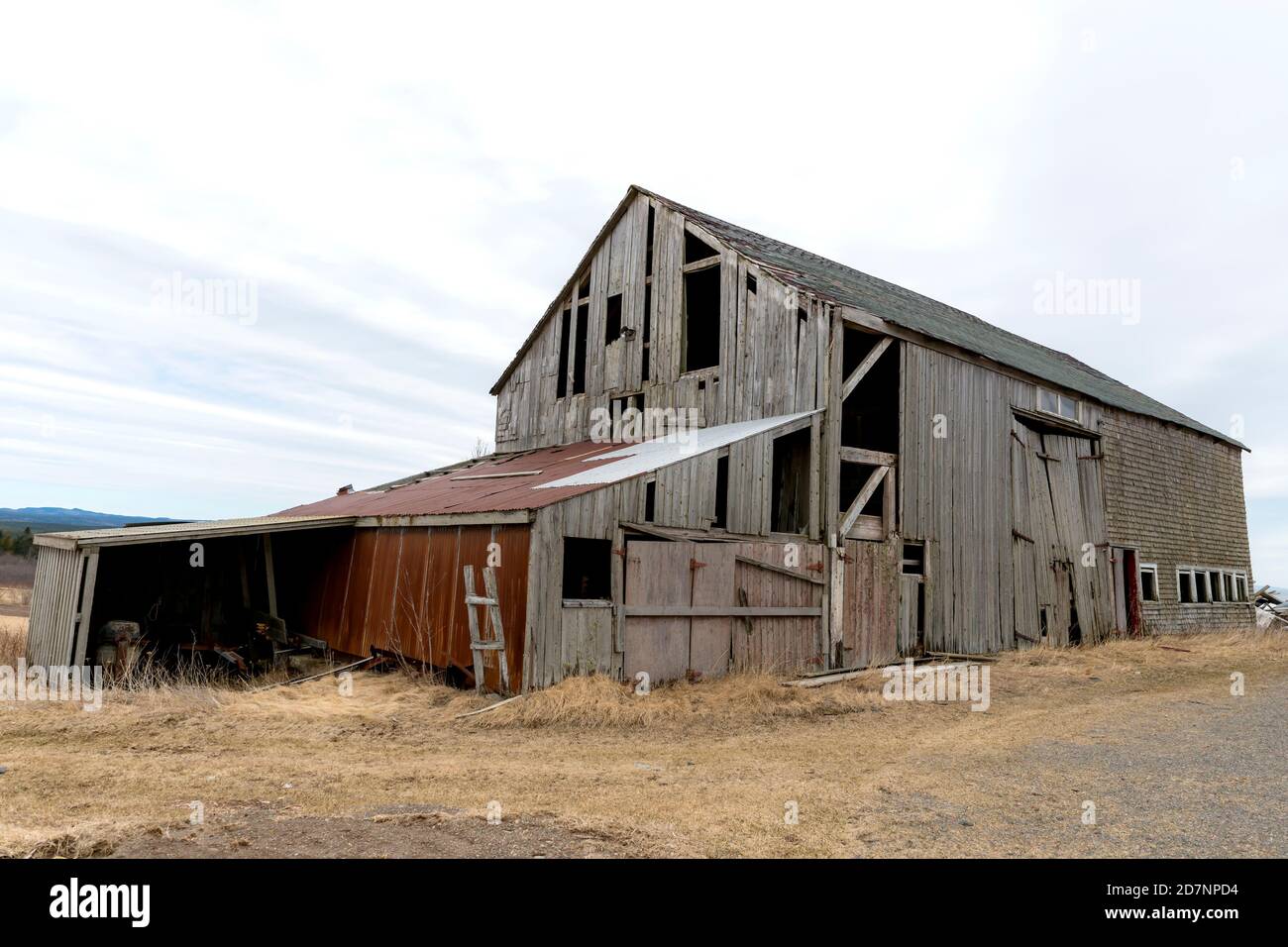An old abandoned barn. There are holes and missing pieces in the walls ...