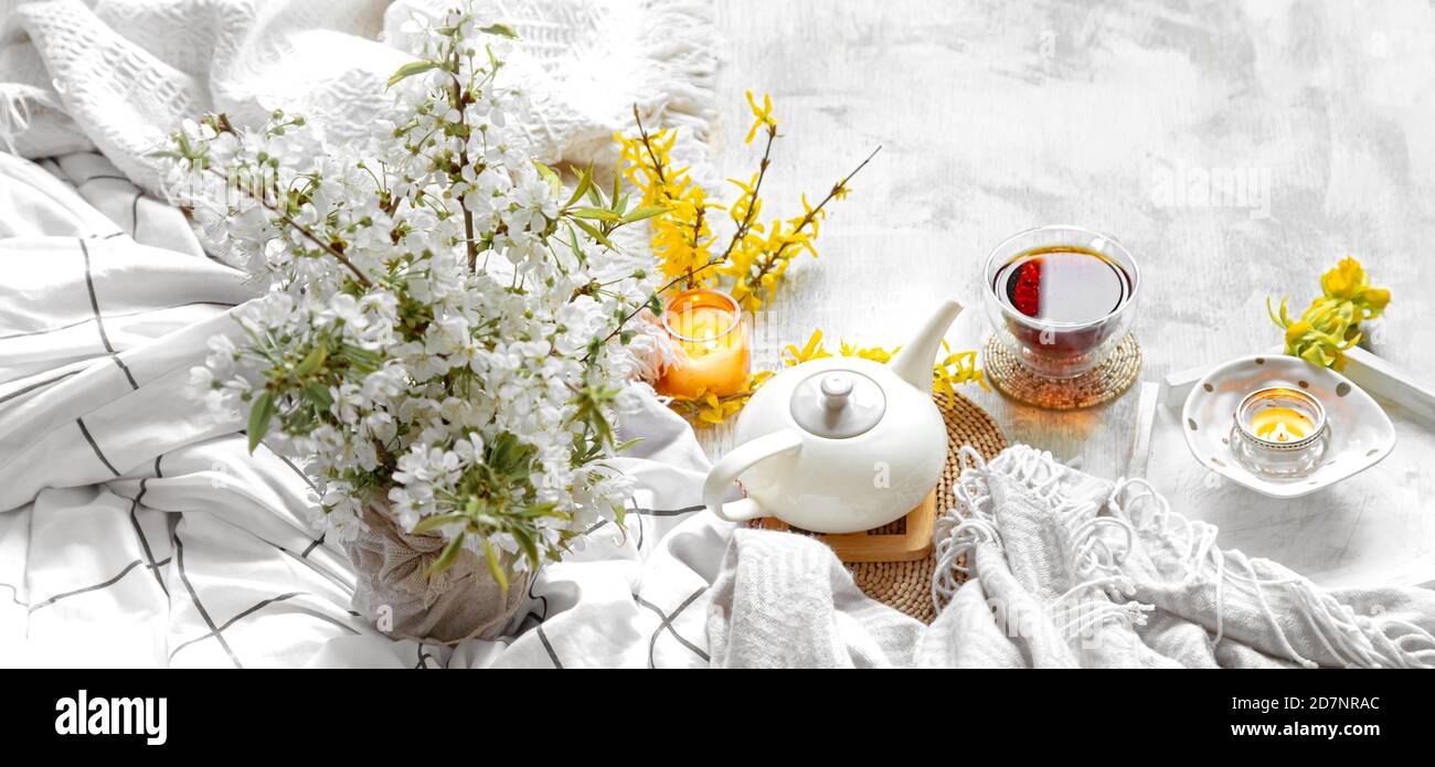 Spring still life with a Cup of tea and flowers . Light background ...