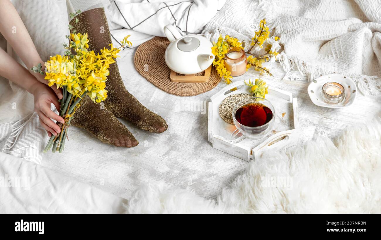 Spring still life with a Cup of tea and flowers . Light background ...