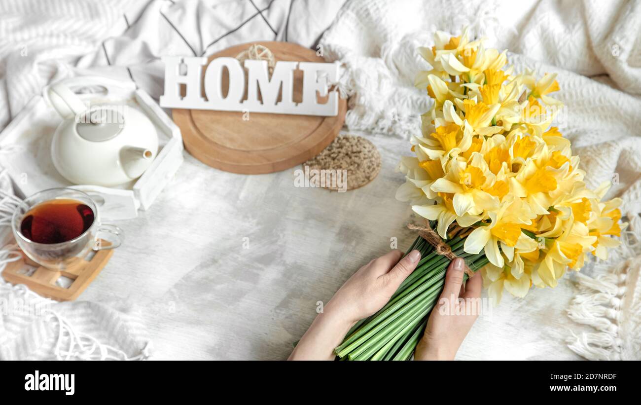 Spring still life with a Cup of tea and flowers . Light background ...