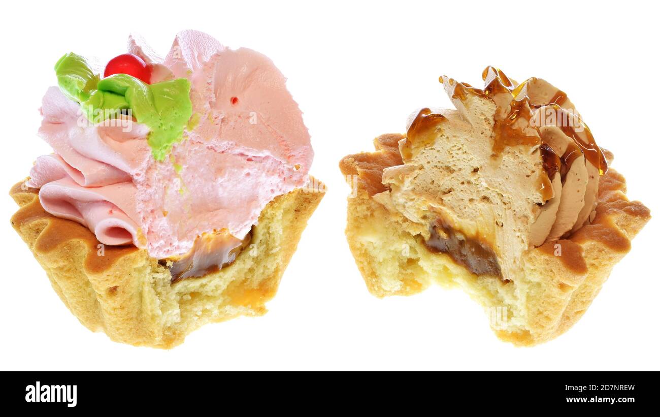 Two bitten tartlet cake with strawberry cream and caramel filling, top ...