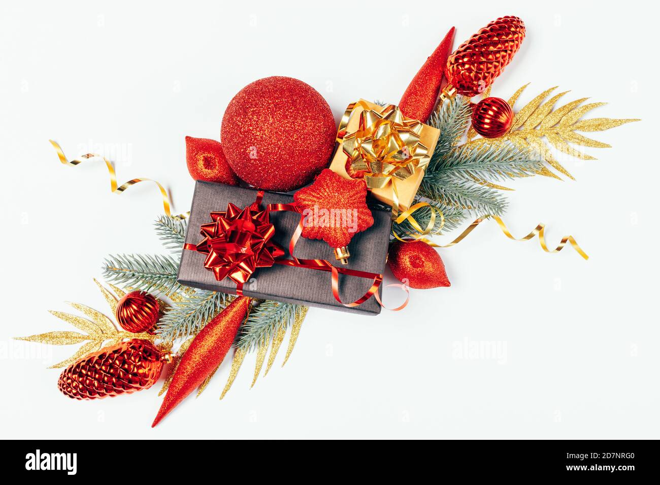 Festive Christmas arrangement with gift boxes, fir branches and red ...