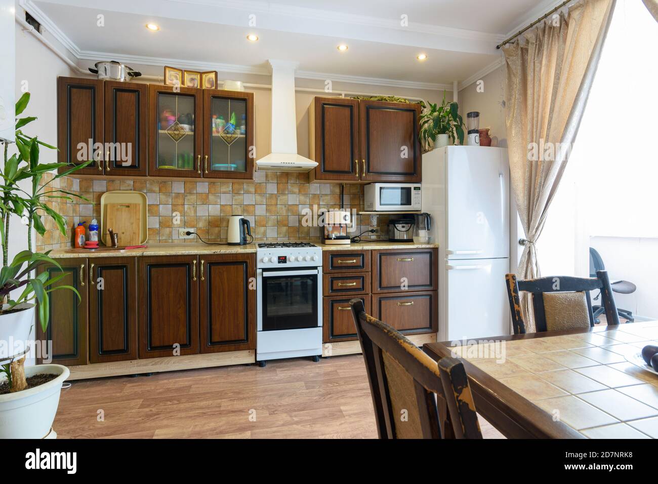 Classic wood grain kitchen set and dining table in the interior of the ...