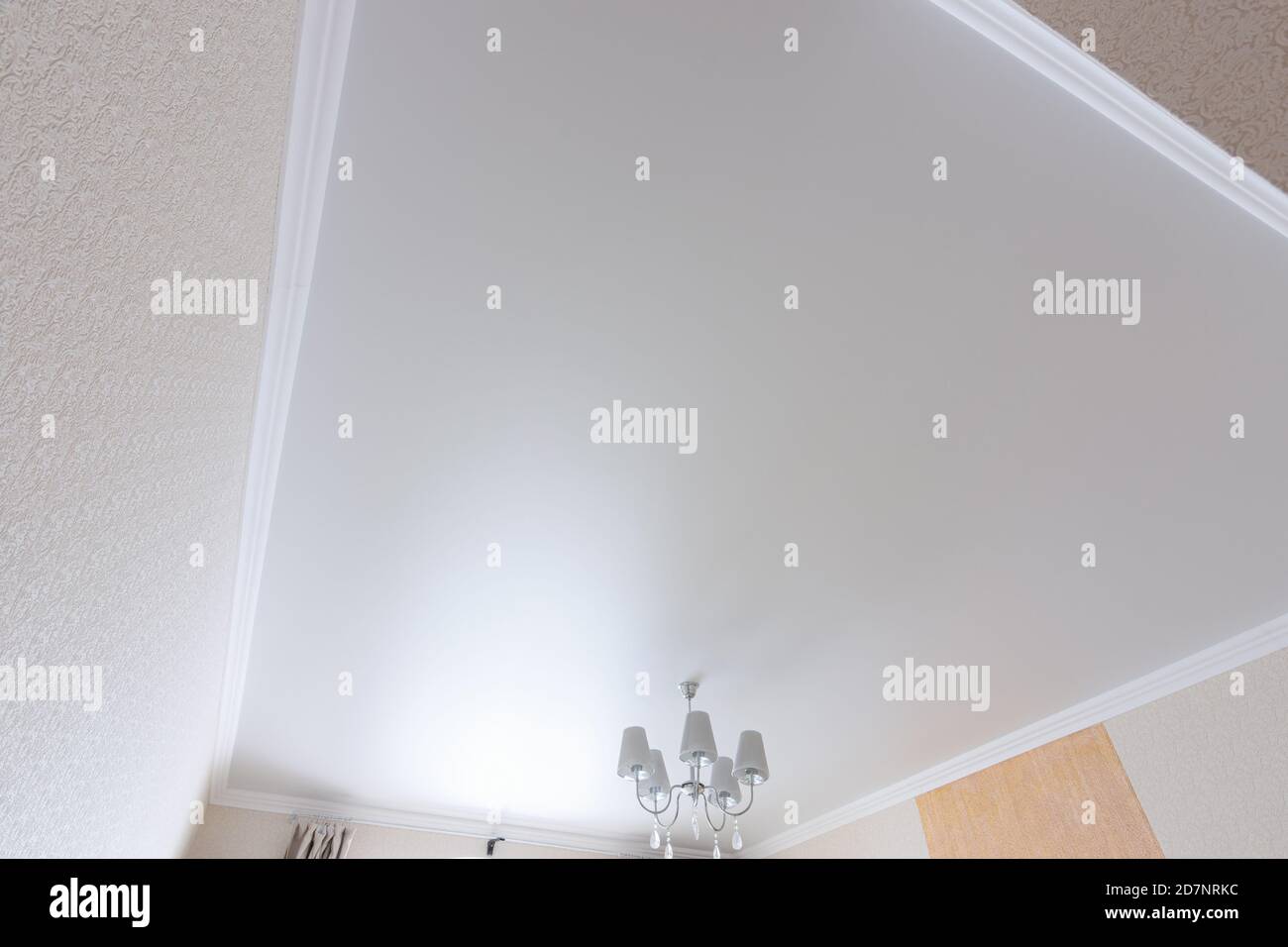 White matte ceiling in a large room close up Stock Photo - Alamy